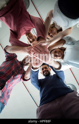 Team of businesspeople forming hand stack in office Stock Photo - Alamy