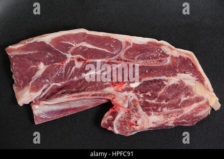 Blade chop in black tray against wooden background Stock Photo - Alamy