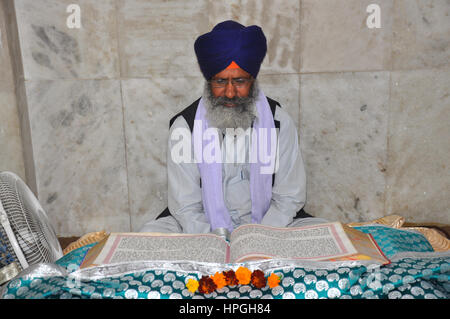 Reading the Sikhism scriptures. The scriptures of Sikhism are known as ...