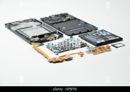 Disassembled smartphone with different electronic parts and lithium ion ...