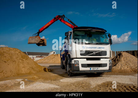 Grab tipper lorry picking up a load of aggregate Stock Photo - Alamy