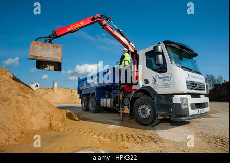 Grab tipper lorry picking up a load of aggregate Stock Photo - Alamy