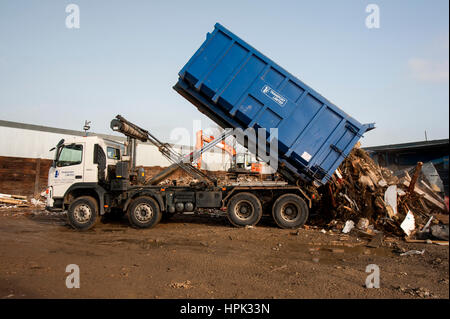 Commercial skip lorry emptying a large waste skip Stock Photo - Alamy