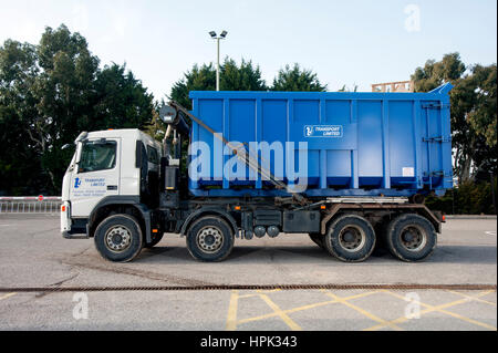 A large skip dumpster truck lorry unloading waste at a recycling centre ...