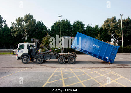 Lorry truck loading a skip waste management container Stock Photo - Alamy