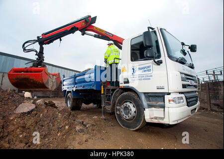 Grab tipper lorry picking up a load of aggregate Stock Photo - Alamy