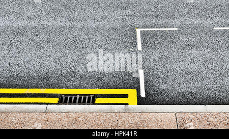 Road markings and pavement with kerb white lines and yellow lines ...