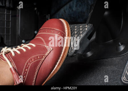 Car accelerate and brake foot pedal. Close up foot press or push foot ...
