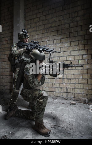 Pair of Army Rangers with rifle and machine gun moving along the ...