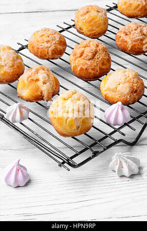 Homemade profiteroles eclairs on the grid for baking Stock Photo - Alamy