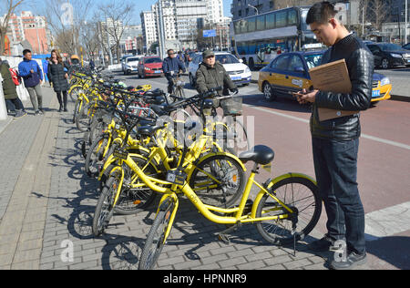 A man uses Bike-Sharing APP to rent bicycle in Beijing, China. 28-Feb ...