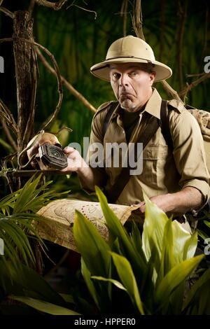 Explorer with old map in the jungle discovering a human skull Stock ...