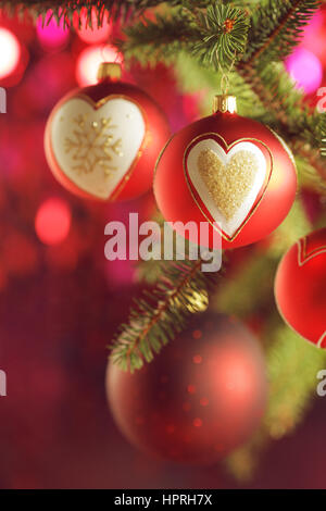 It's Christmas, red balls hangs from a frosted pine tree Stock Photo ...
