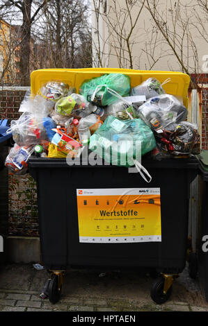 Germany Berlin overflowing rubbish bin and littered lawn in the ...