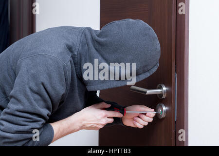 Intruder breaking into a house Stock Photo - Alamy