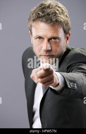Handsome businessman pointing towards the camera Stock Photo - Alamy