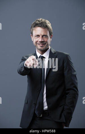 Handsome businessman pointing towards the camera Stock Photo - Alamy
