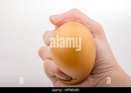 Squeezing yellow balloon with hand on a white background Stock Photo ...