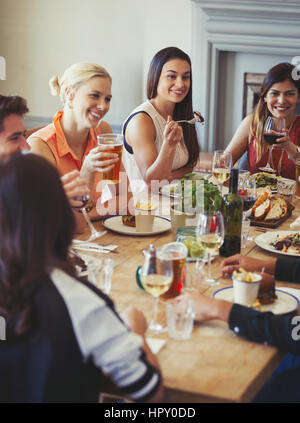 Friends talking and dining at restaurant table Stock Photo - Alamy