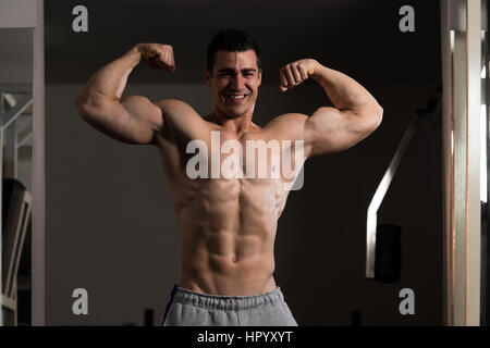 Bodybuilder Posing In Different Poses Demonstrating Their Muscles ...