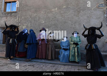 Revelers wearing traditional bull-head masks take part in the ...