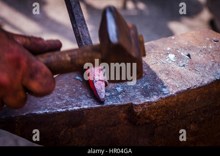 Iron metal being forged Stock Photo - Alamy