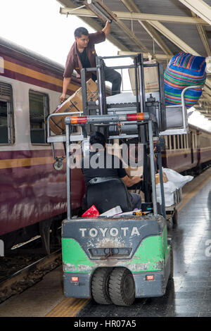 Men loaded packages into the train through the window of the car ...