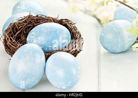 Vibrant colored eggs in a nest on green. Easter concept Stock Photo - Alamy