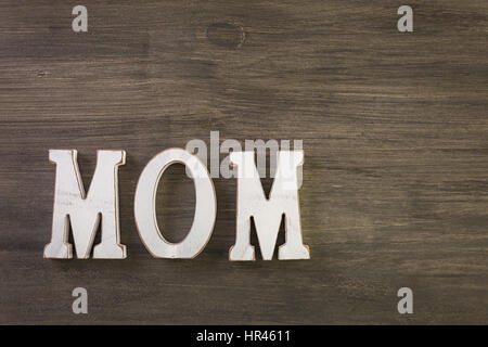 White letters MOM on a painted wood background Stock Photo - Alamy