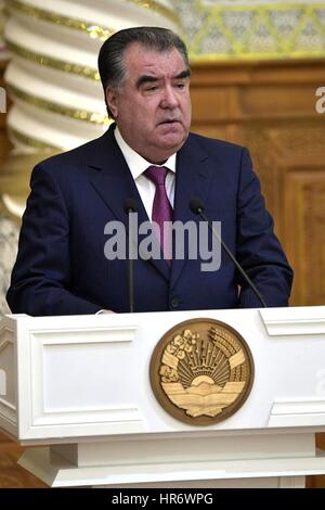 A portrait of Tajik President Emomali Rahmon hangs over a swimming pool ...