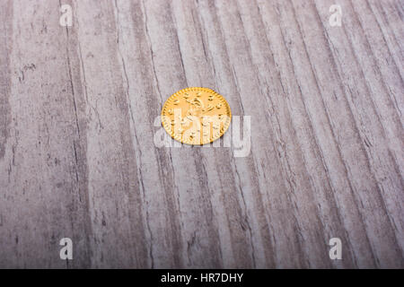 Fake gold coin placed gray background Stock Photo - Alamy