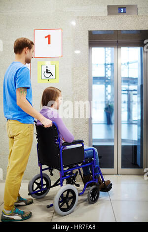 Young physically impaired girl sitting in wheelchair at mall food Stock ...