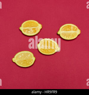 Lemons on red background Stock Photo - Alamy