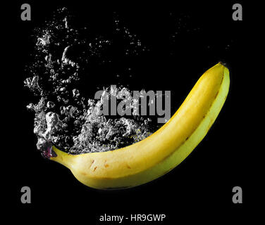 Banana dropped into water on black background. Air bubbles in water Stock Photo - Alamy