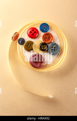 Colourful buttons and ribbon roll in closeup Stock Photo - Alamy