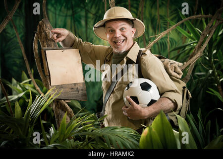 Smiling explorer in the jungle holding skull and machete Stock Photo ...