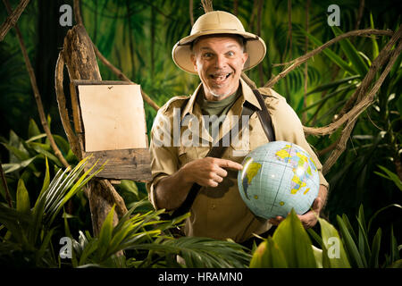 Cheerful vintage explorer in the jungle with map and blank sign Stock ...
