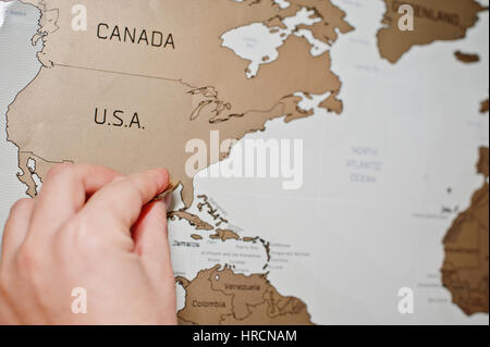 Scratch travel map of the world. Hand of man erase Africa Nigeria with ...