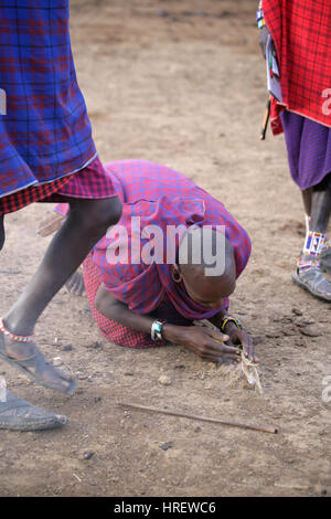 Maasai warriors making fire Masai Mara National Nature Reserve Kenya ...