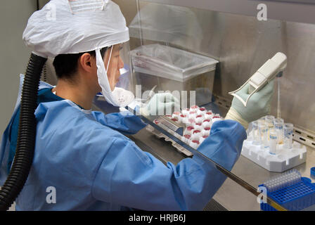 Centers for Disease Control (CDC) scientist in a protective air-tight ...
