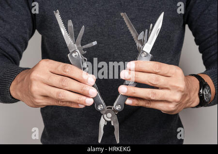closeup multifunction stainless steel knife in hand Stock Photo - Alamy