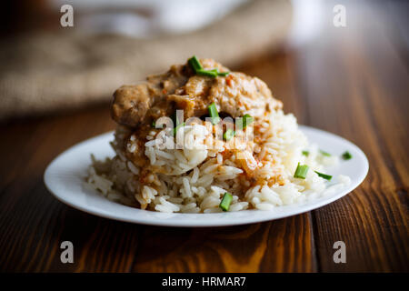 Boiled rice with rabbit meat and sauce Stock Photo - Alamy