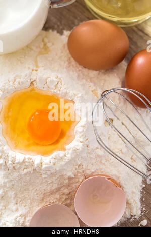 Breaking bread on wooden table Stock Photo - Alamy