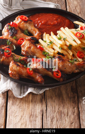 Baked chicken wings with French fries on slate plate Stock Photo - Alamy