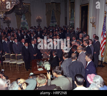 US President Lyndon B. Johnson signs the 1964 Civil Rights Act as Stock ...