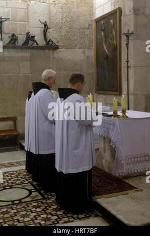 Franciscan friars praying in Chapel of St. Helena inside the Church of ...
