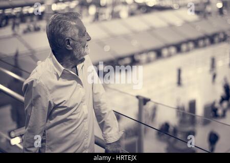 Man staring at the airport crowd downstairs Stock Photo - Alamy