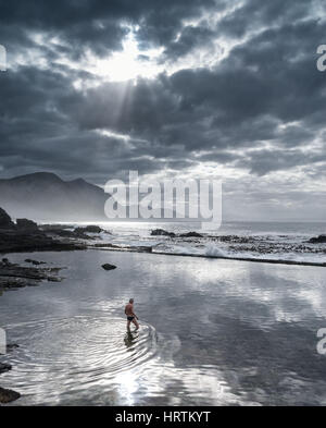 Hermanus, South Africa - Still waters of tidal pool reflects the sky at ...