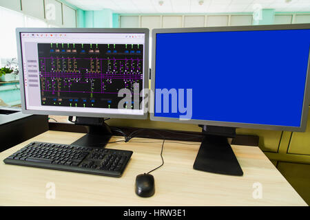 Computers and monitors with schematic diagram for supervisory, control ...