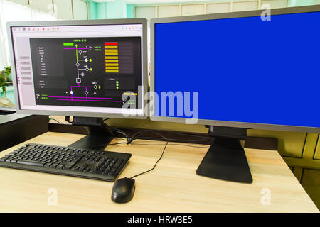 Computers and monitors with schematic diagram for supervisory, control ...